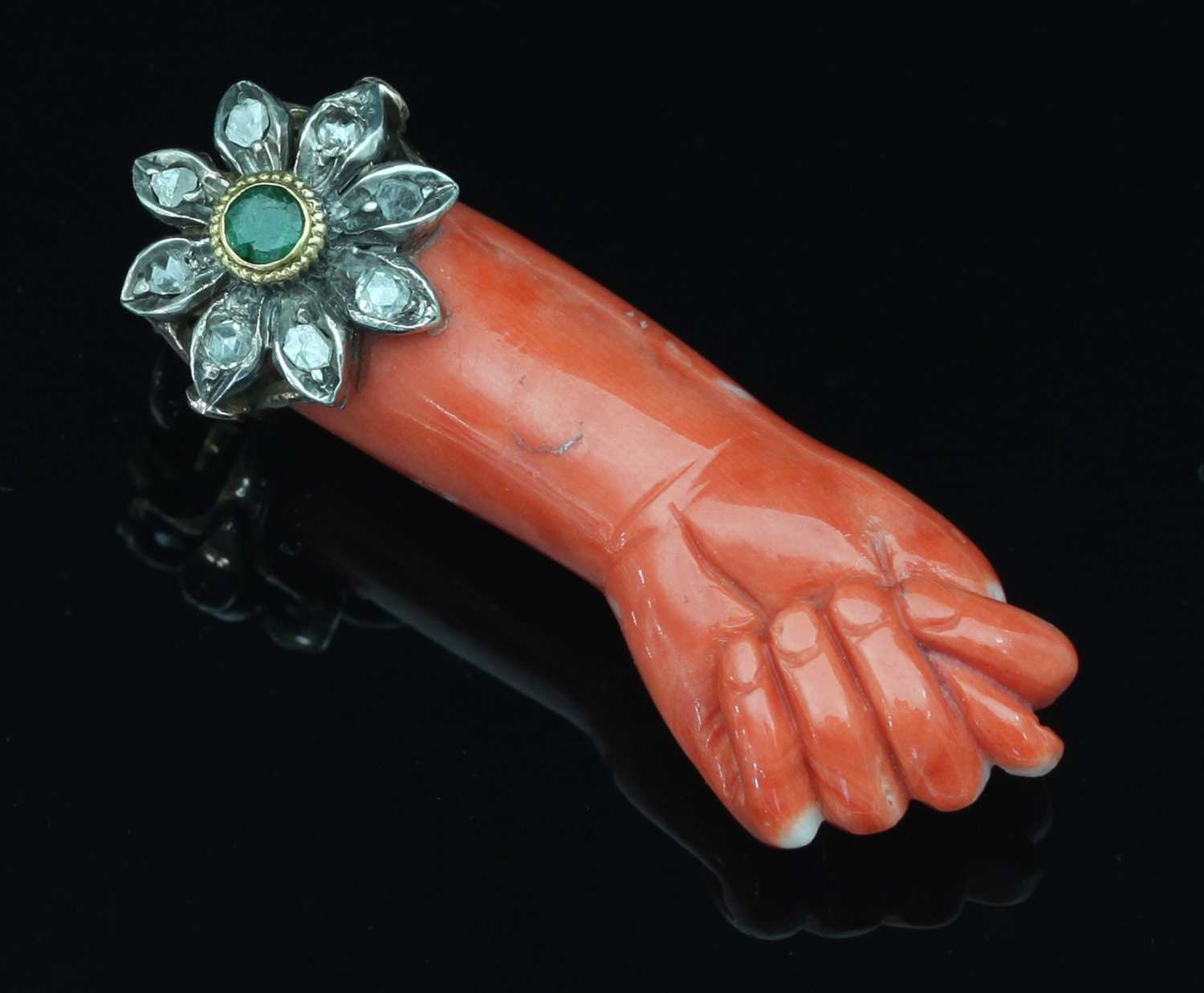 Lot 118 - A carved coral higa symbol pendant, the